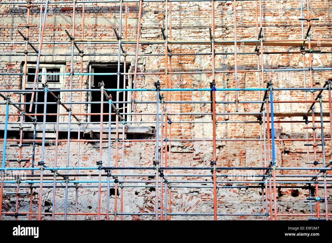 Scaffolding around a brick building renovating facade Stock Photo - Alamy