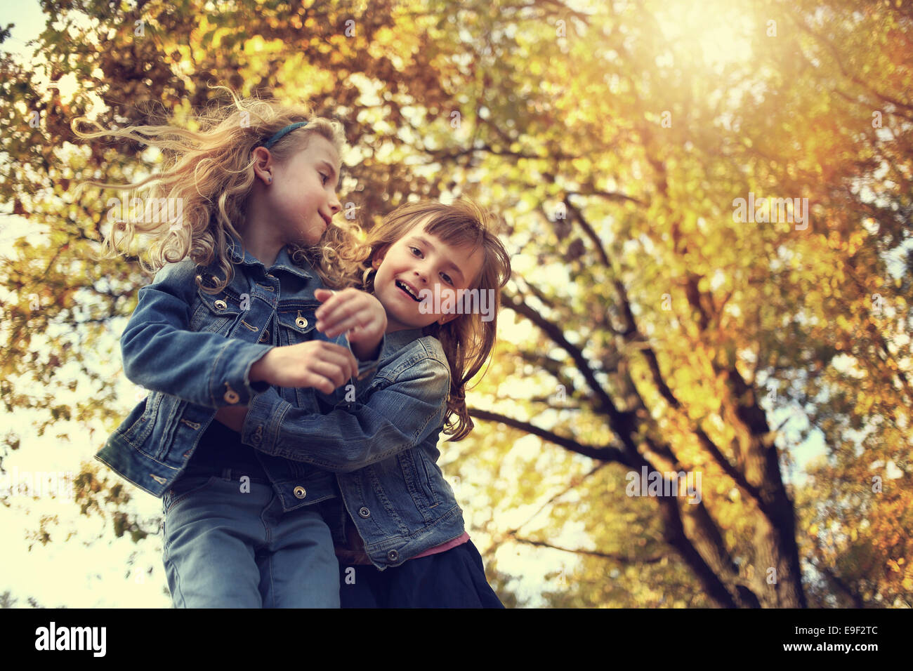Young girls play outdoors Stock Photo - Alamy