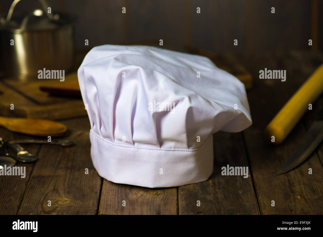 chef hat with kitchen settings and rustic look Stock Photo - Alamy