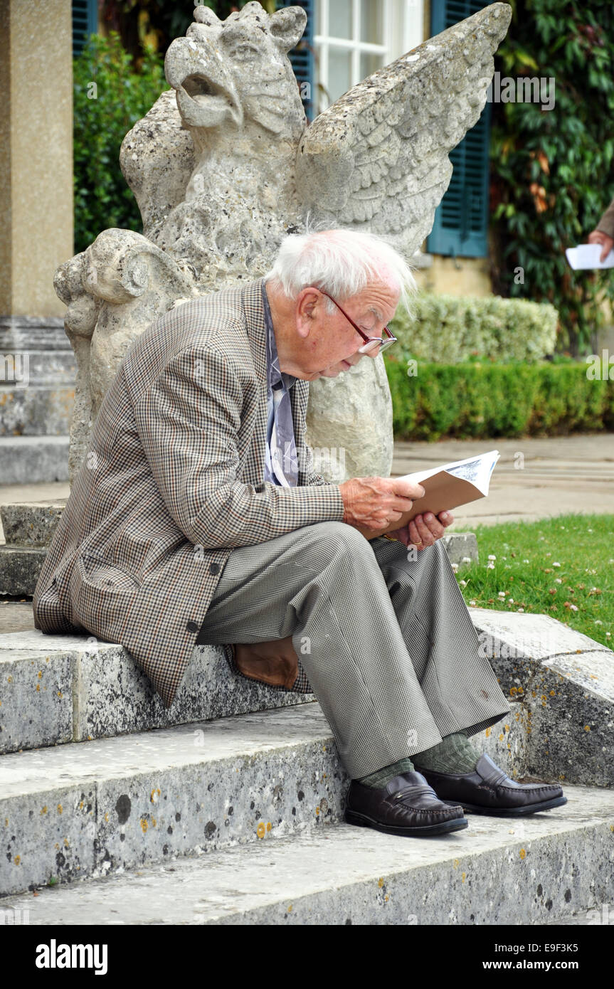Bespectacled well dressed old man with white hair, wearing a ...