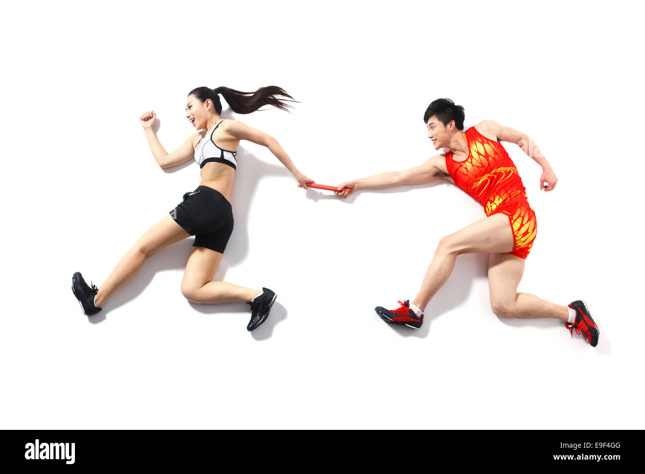 Athletes running passing the baton Stock Photo - Alamy
