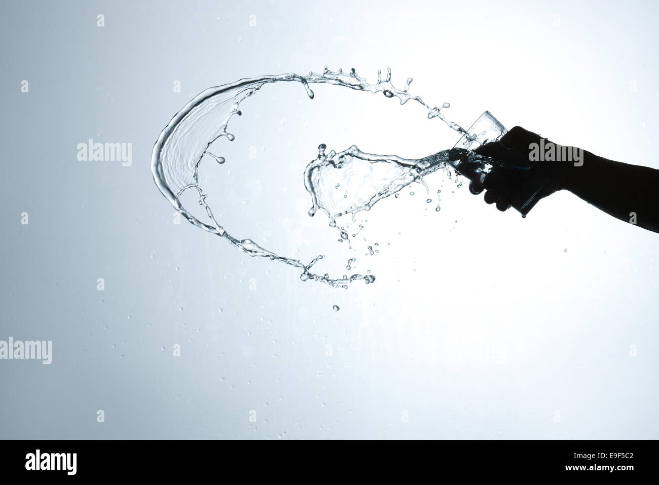 Holding a cup pour splash Stock Photo - Alamy
