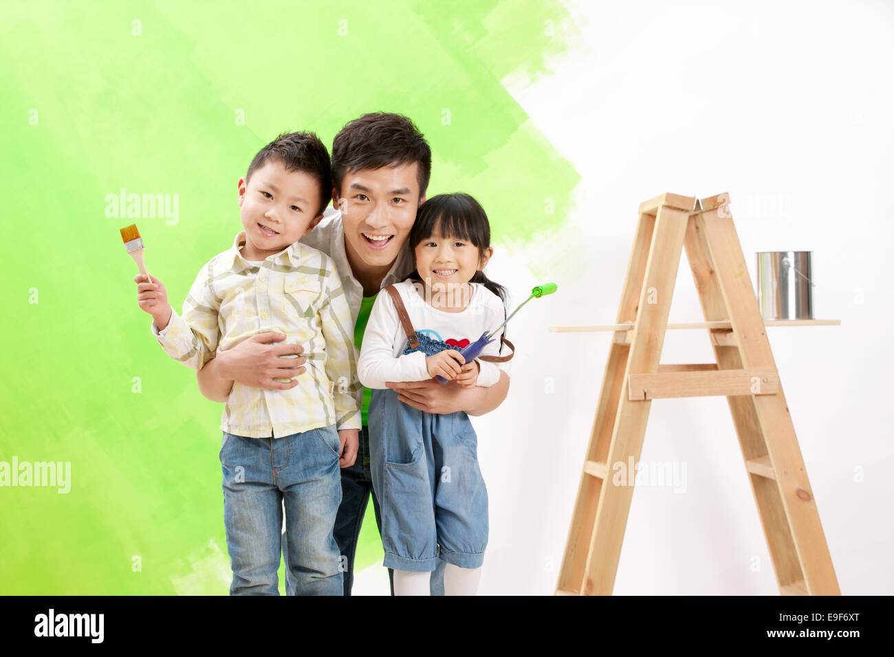 Happy family decorating the house Stock Photo - Alamy