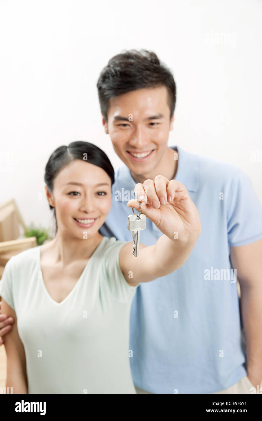 Young couple holding keys Stock Photo - Alamy