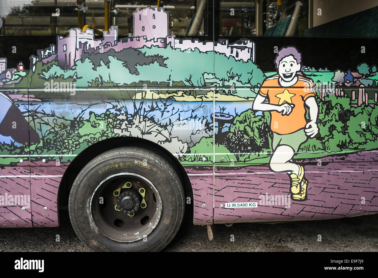 Active male part of an illustrative mural on side of a public service ...