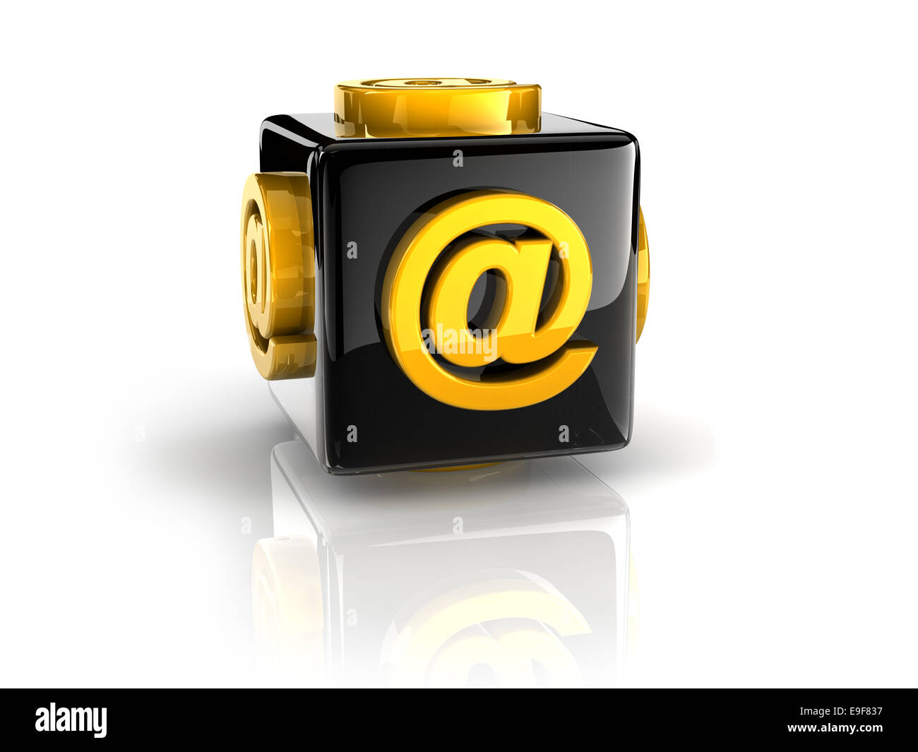 gold at symbol on reflective black cube isolated with white background ...
