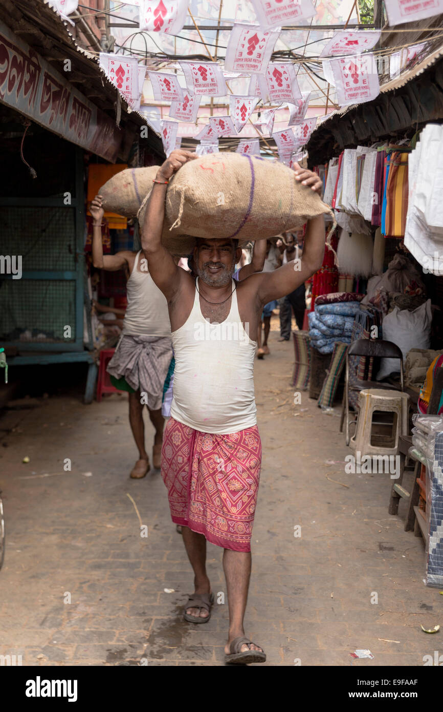 Man carrying weights on his head, Kolkata, West Bengal, India Stock ...