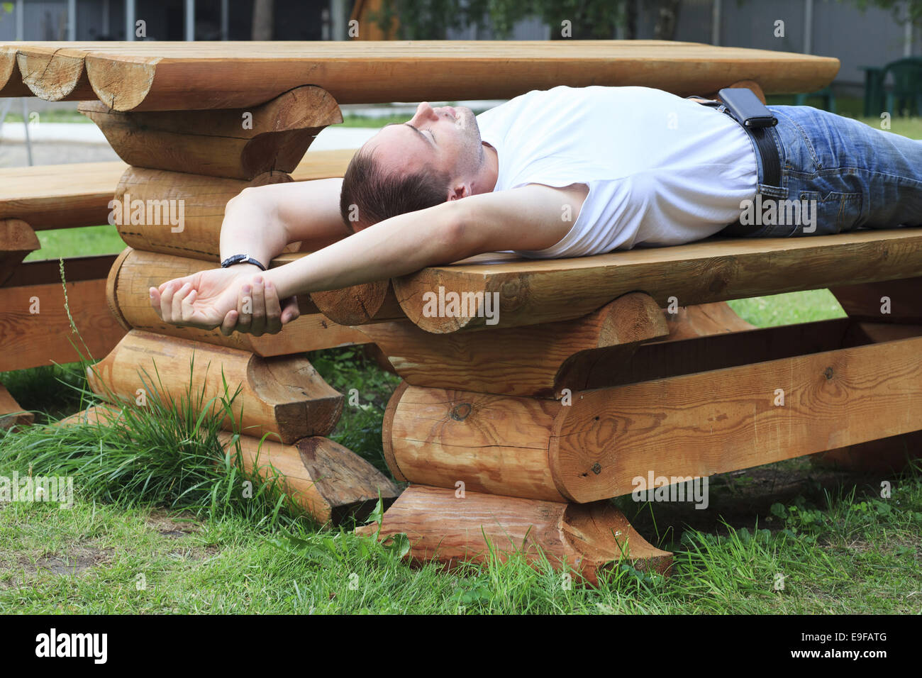 Man sleeps on a wooden bench Stock Photo - Alamy
