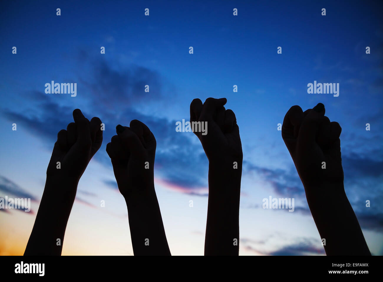 Four raised clenched fists Stock Photo - Alamy