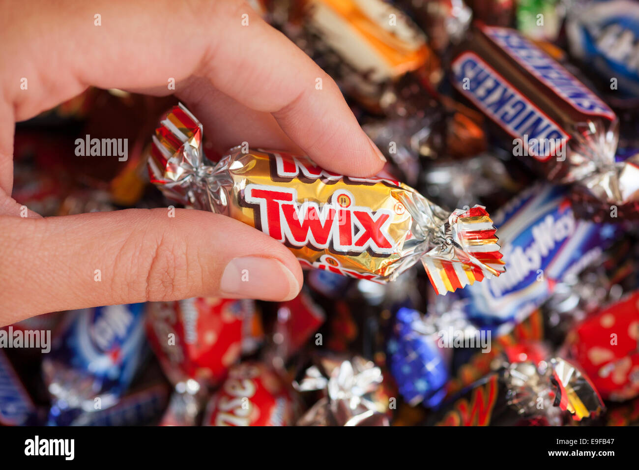 Paphos, Cyprus - December 19, 2013 Twix candy in woman's hand with ...
