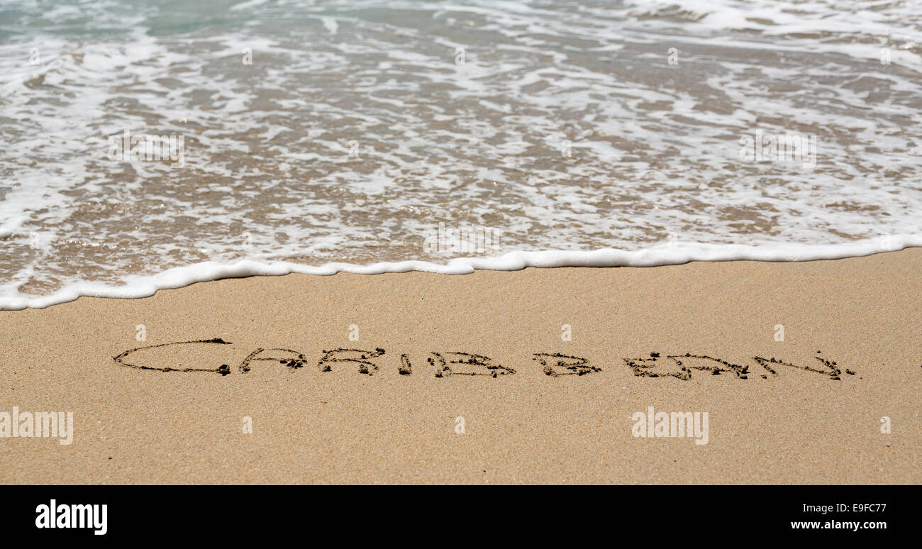 Caribbean written in sand with sea surf Stock Photo - Alamy