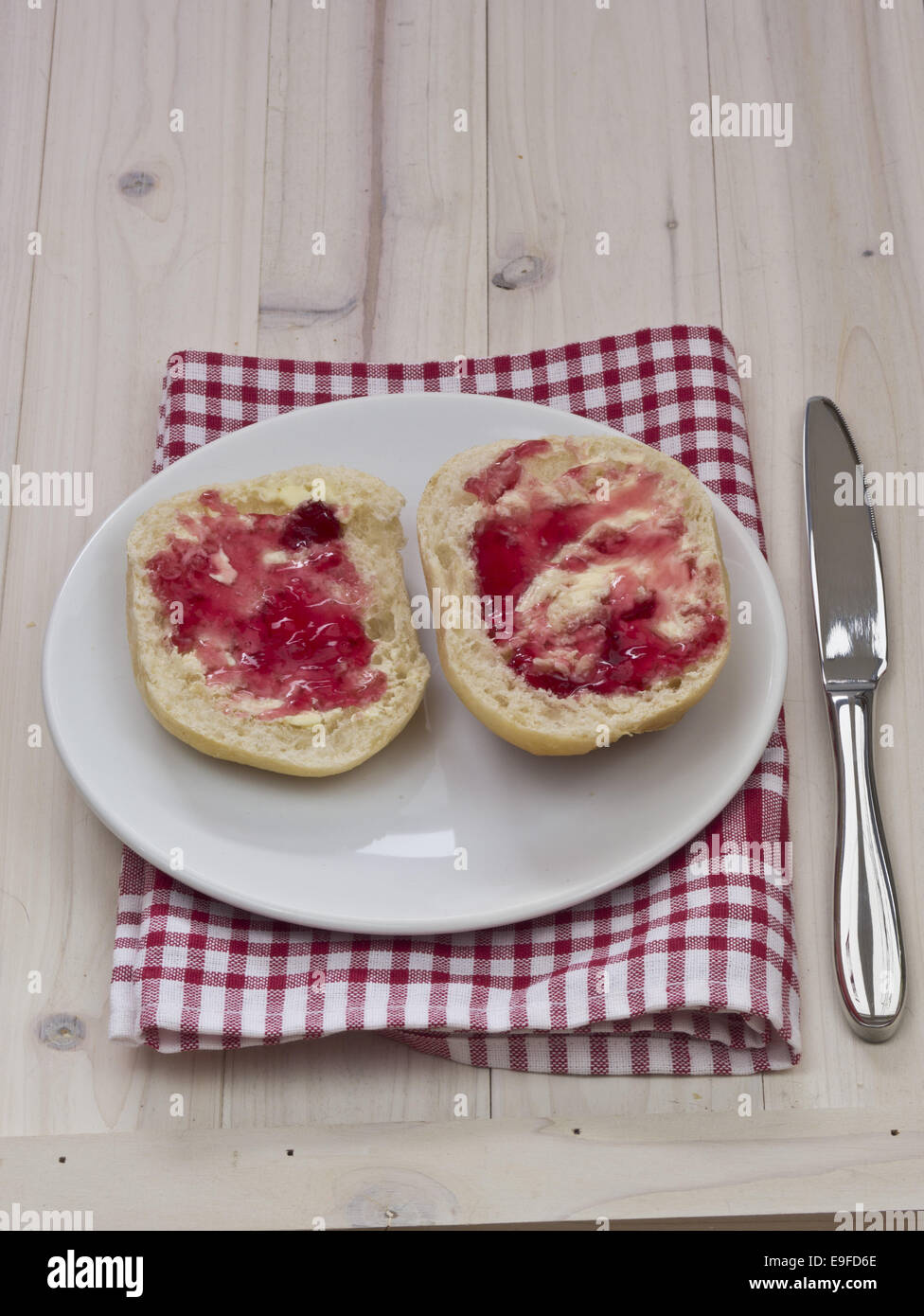 Two bread roll halves with home-baked jam Stock Photo - Alamy