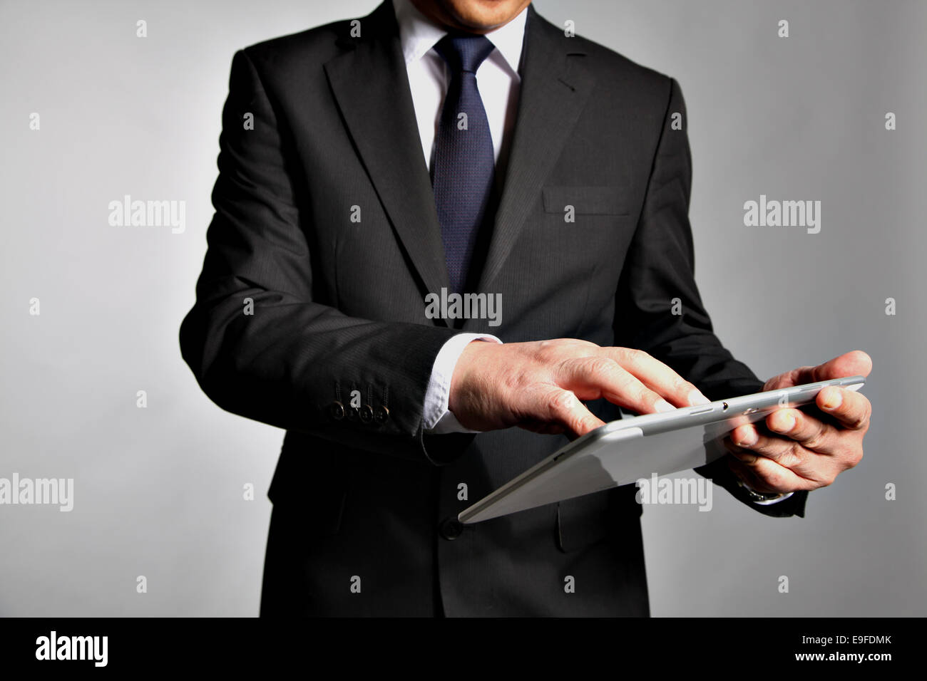 Businessman holds a table pc Stock Photo - Alamy