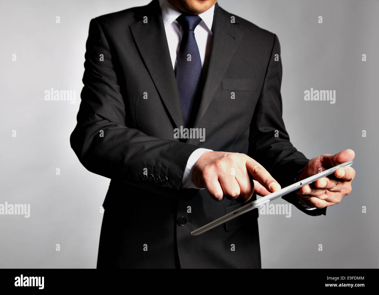 Businessman holds a table pc Stock Photo - Alamy