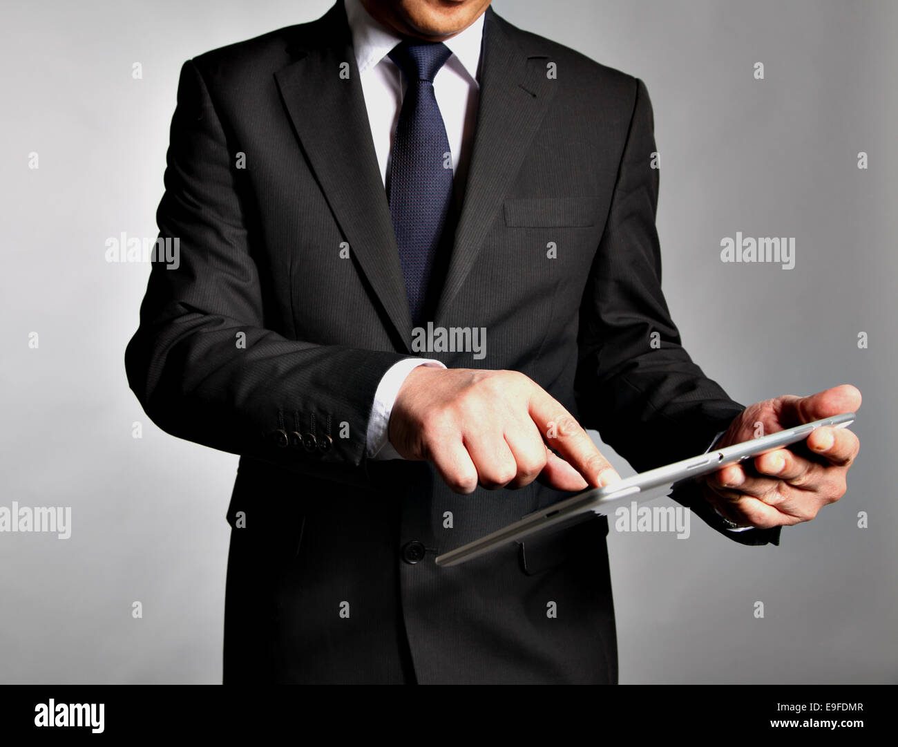 Businessman holds a table pc Stock Photo - Alamy