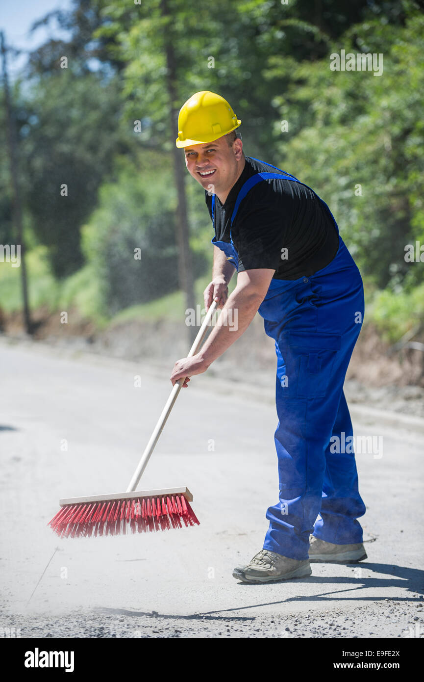 Workers with broom Stock Photo - Alamy