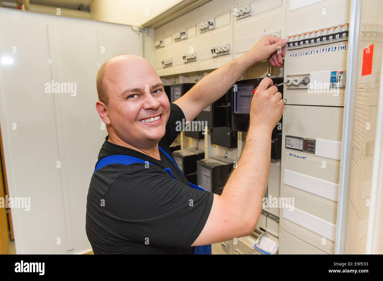 Electrician on cabinet Stock Photo - Alamy
