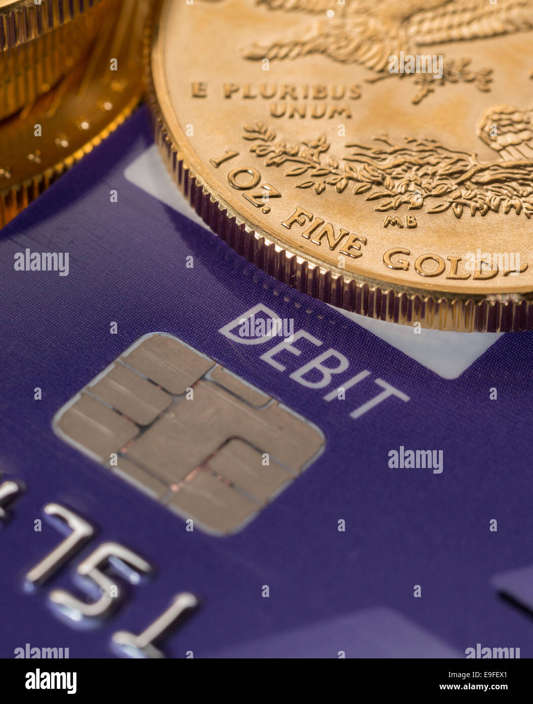Gold coins on chip and pin debit card Stock Photo - Alamy