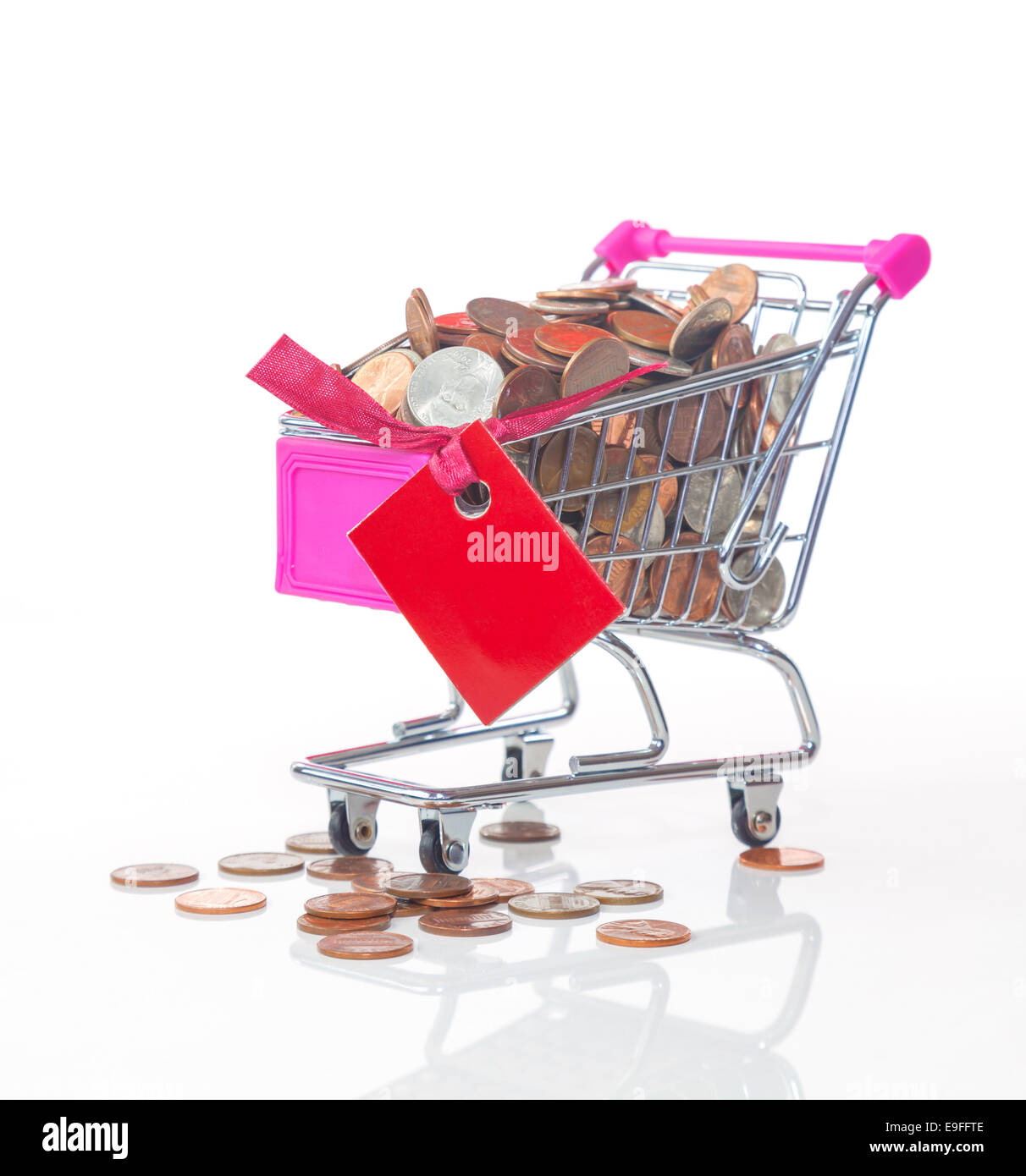 Shopping cart full with coins Stock Photo - Alamy