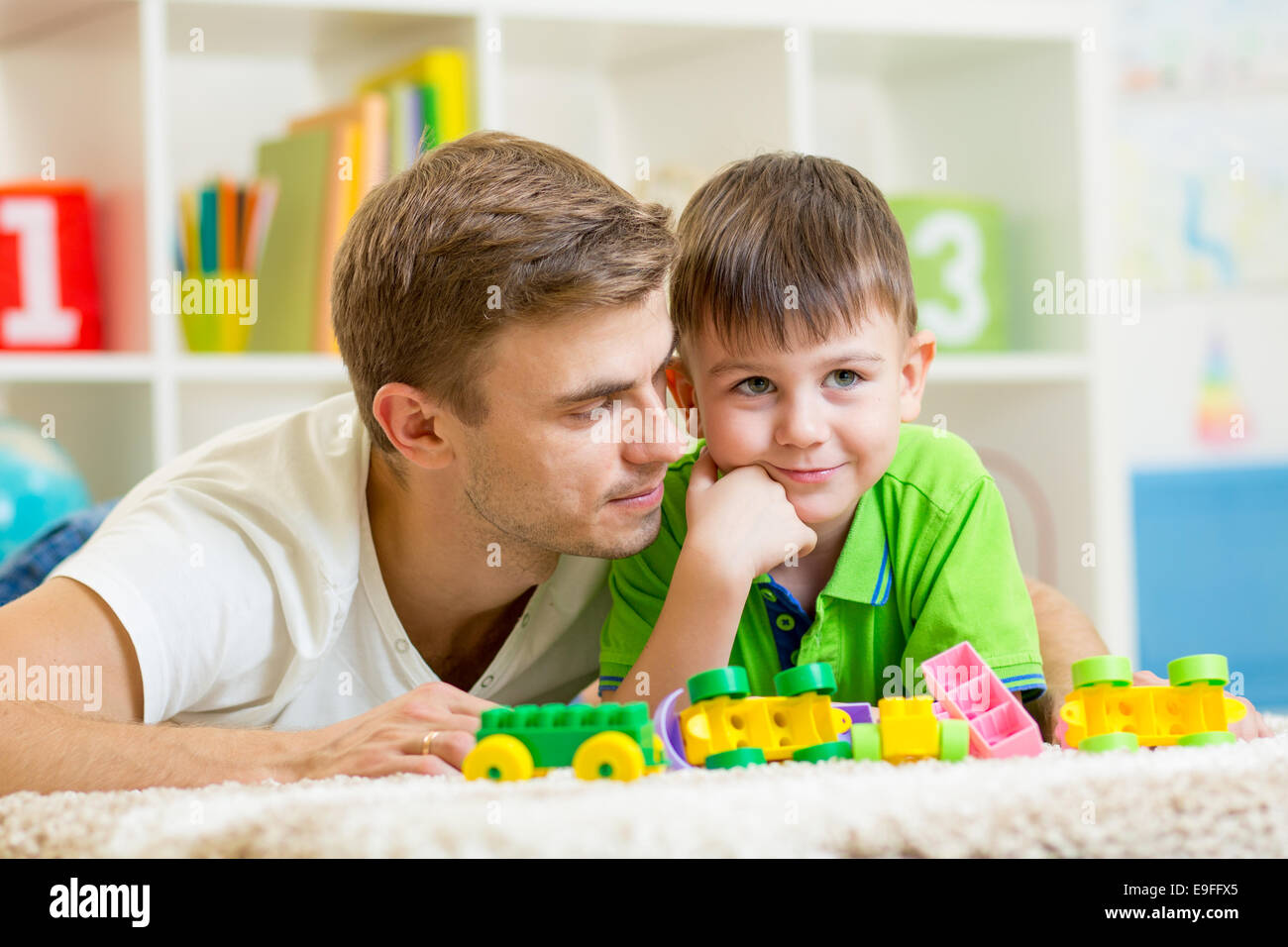 man with his kid son play together at home Stock Photo - Alamy