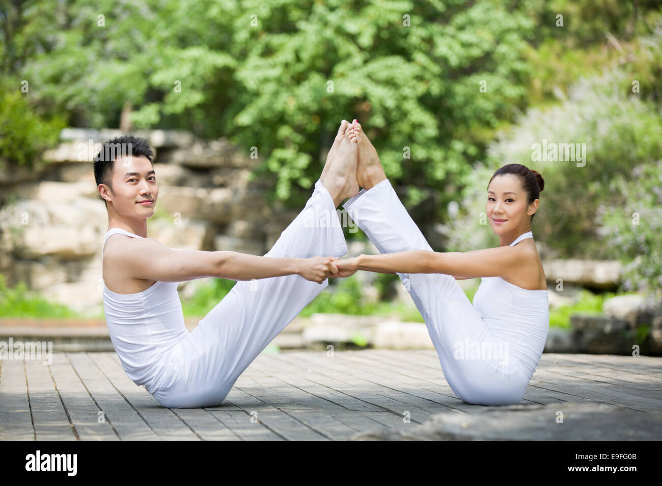 Young couple doing yoga Stock Photo - Alamy