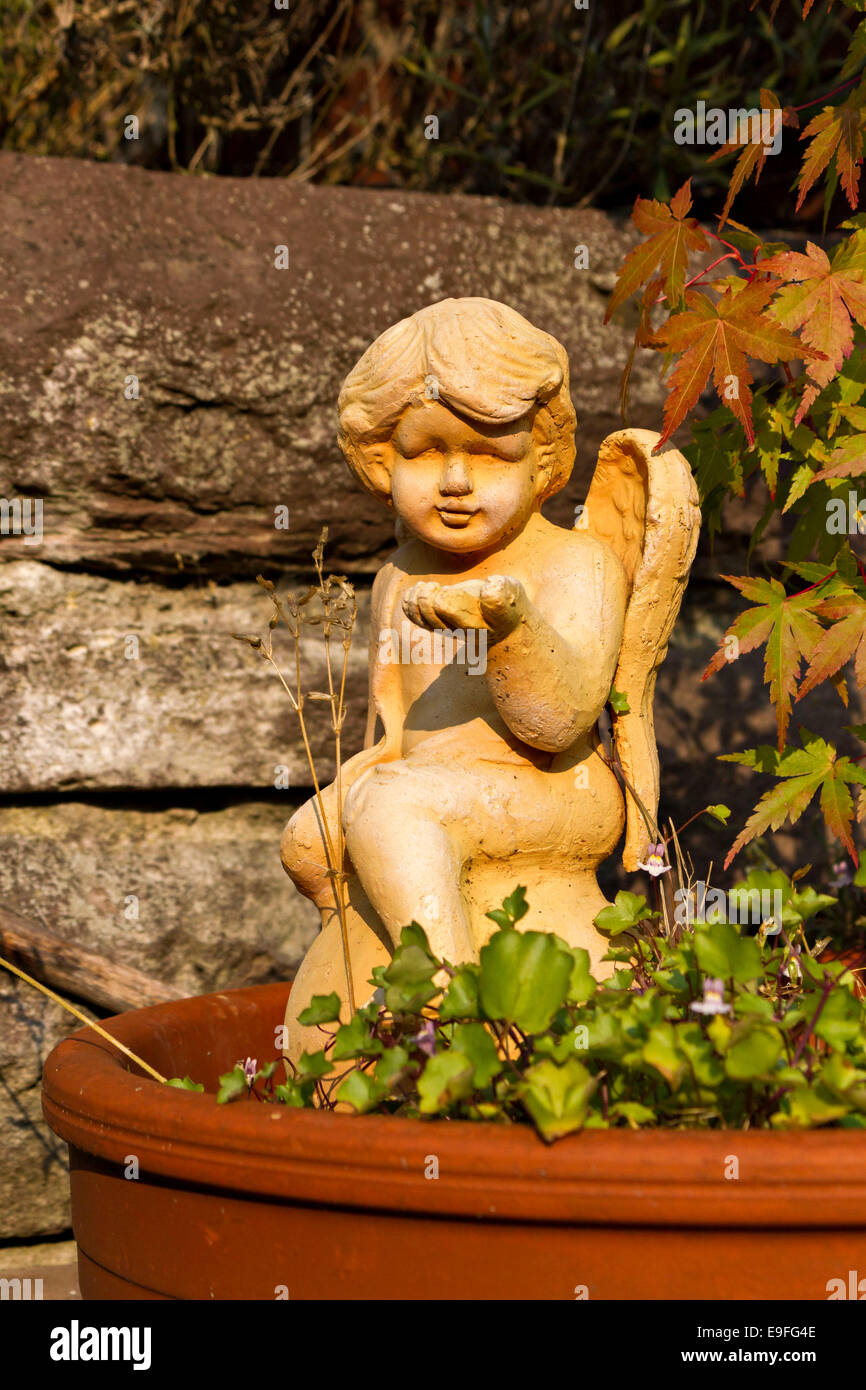 Angel figure in garden flower pot Stock Photo - Alamy