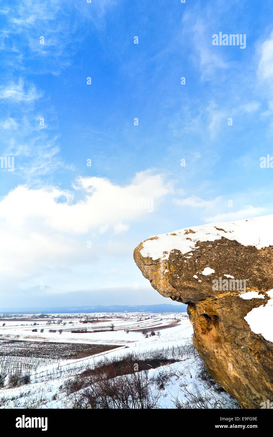 Boulder in snowy landscape Stock Photo - Alamy