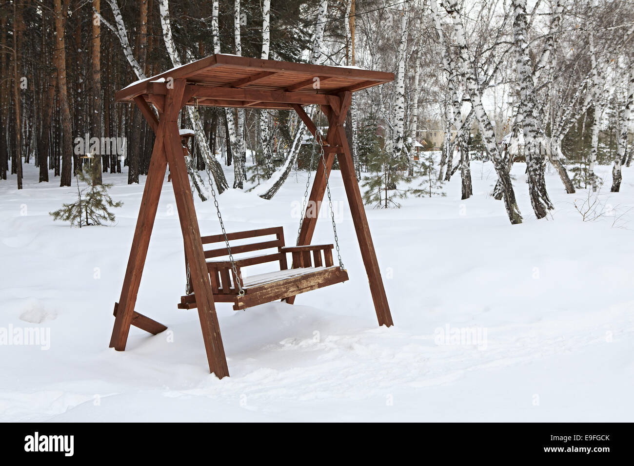 Wooden swing in the winter forest Stock Photo - Alamy