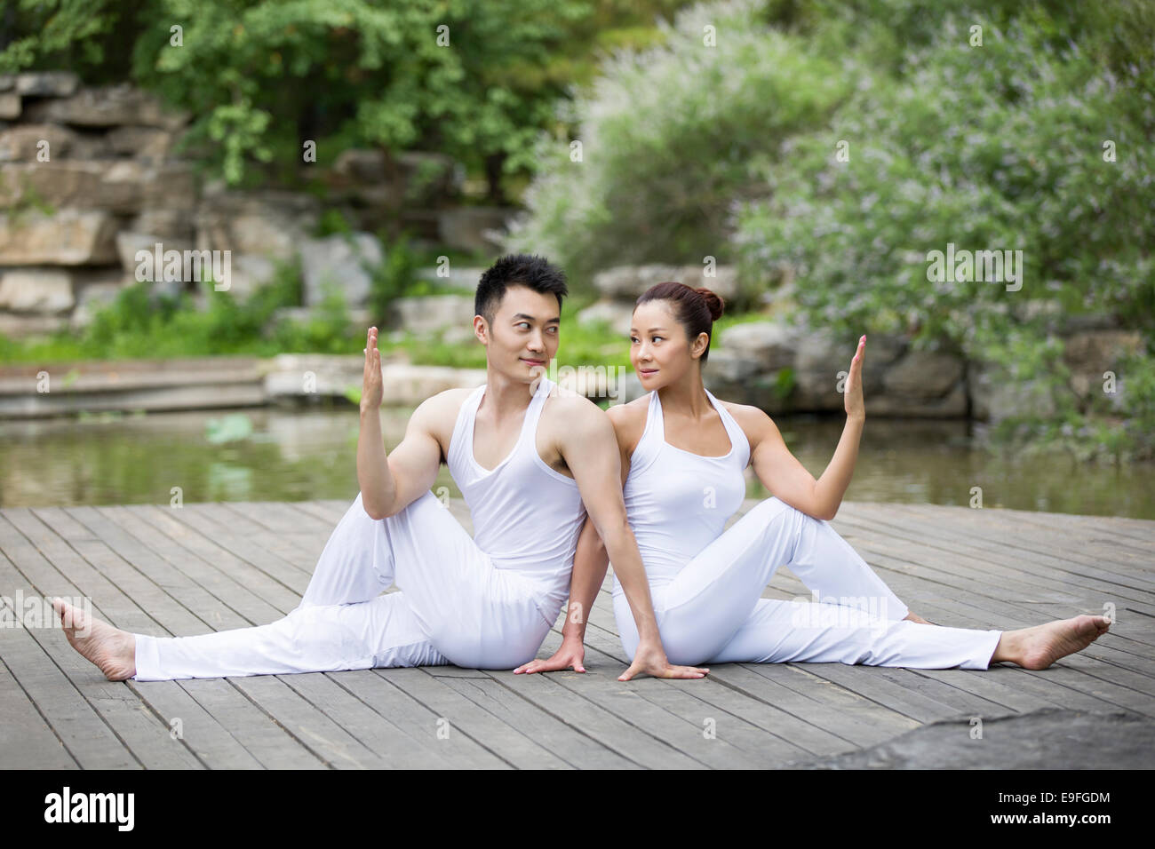 Young couple doing yoga Stock Photo - Alamy