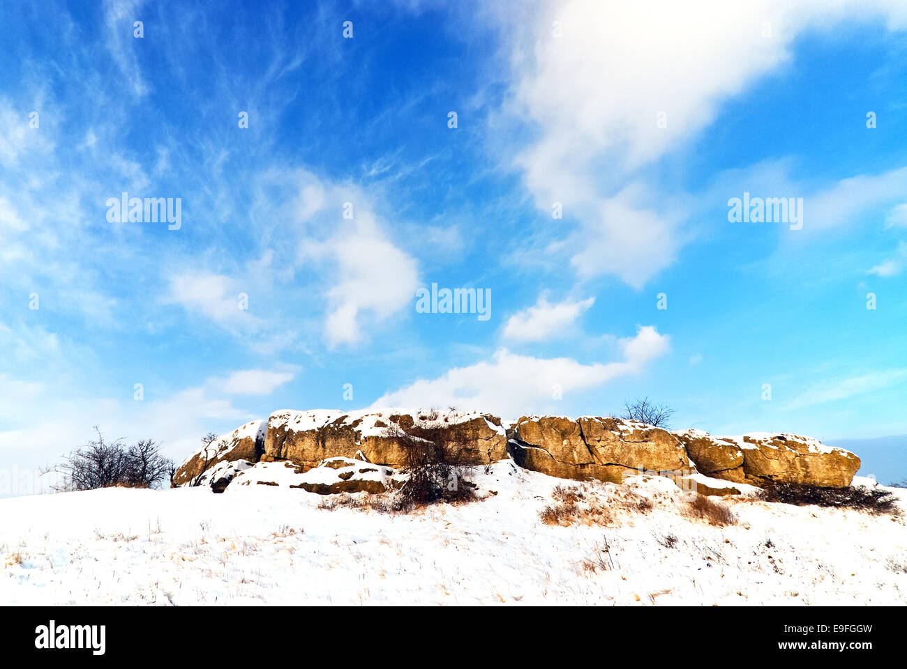 Snowy landscape with boulder Stock Photo - Alamy