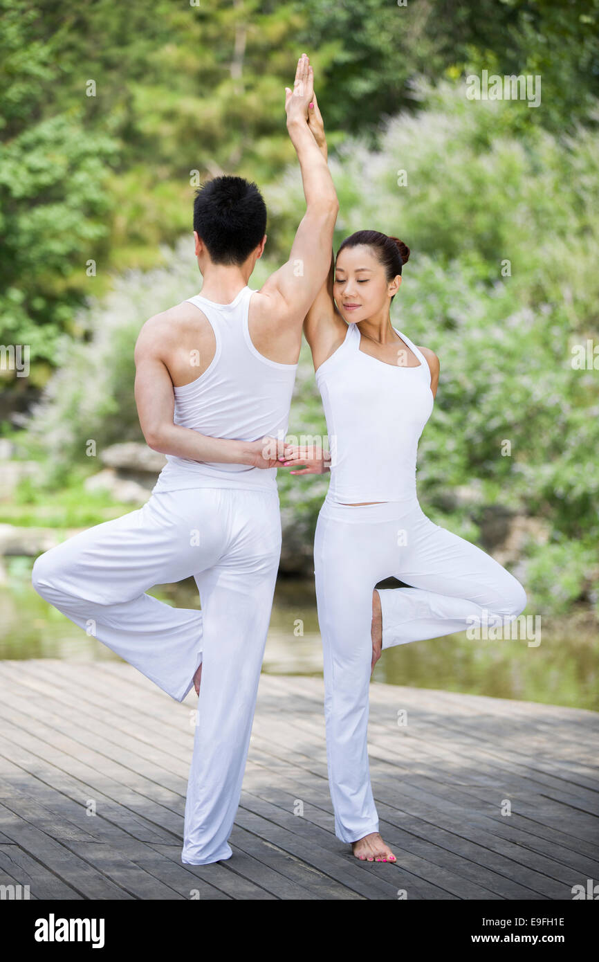 Young couple doing yoga Stock Photo - Alamy