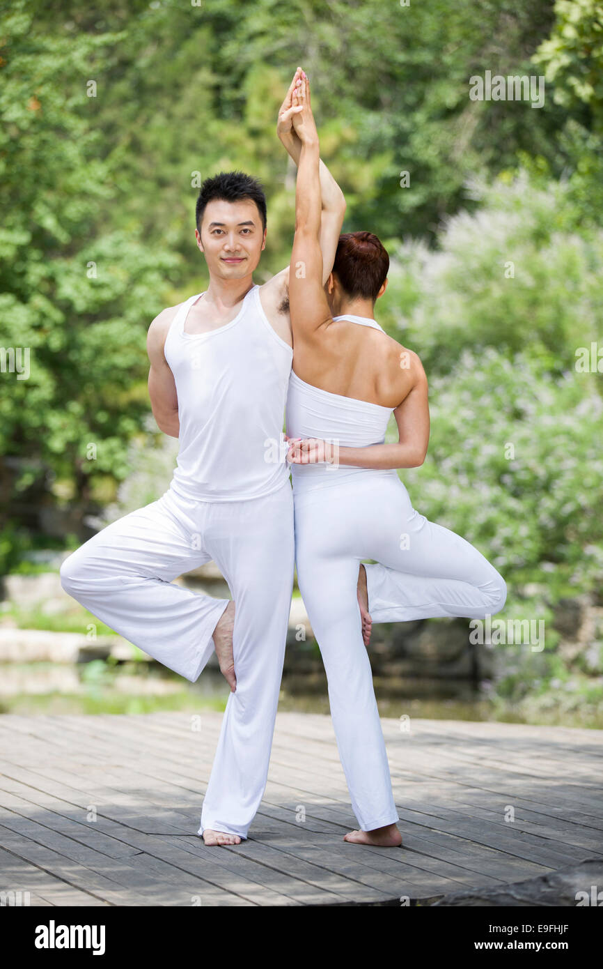 Young couple doing yoga Stock Photo - Alamy