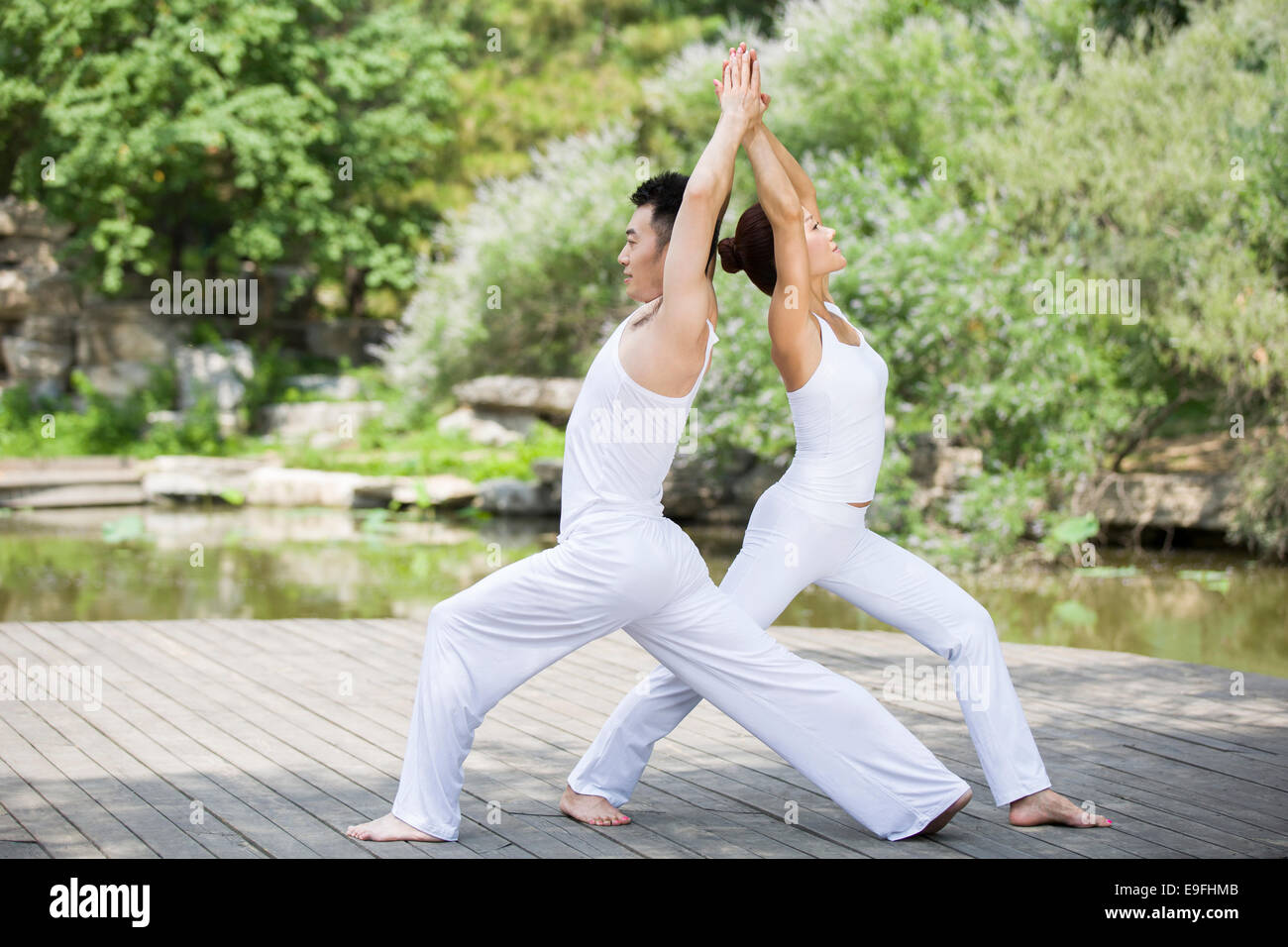 Young couple doing yoga Stock Photo - Alamy