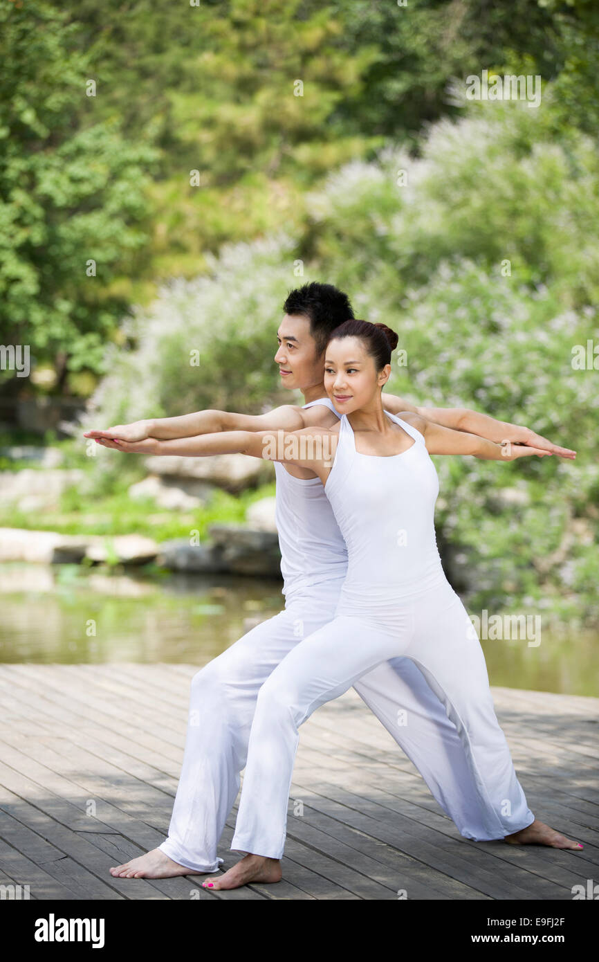 Young couple doing yoga Stock Photo - Alamy