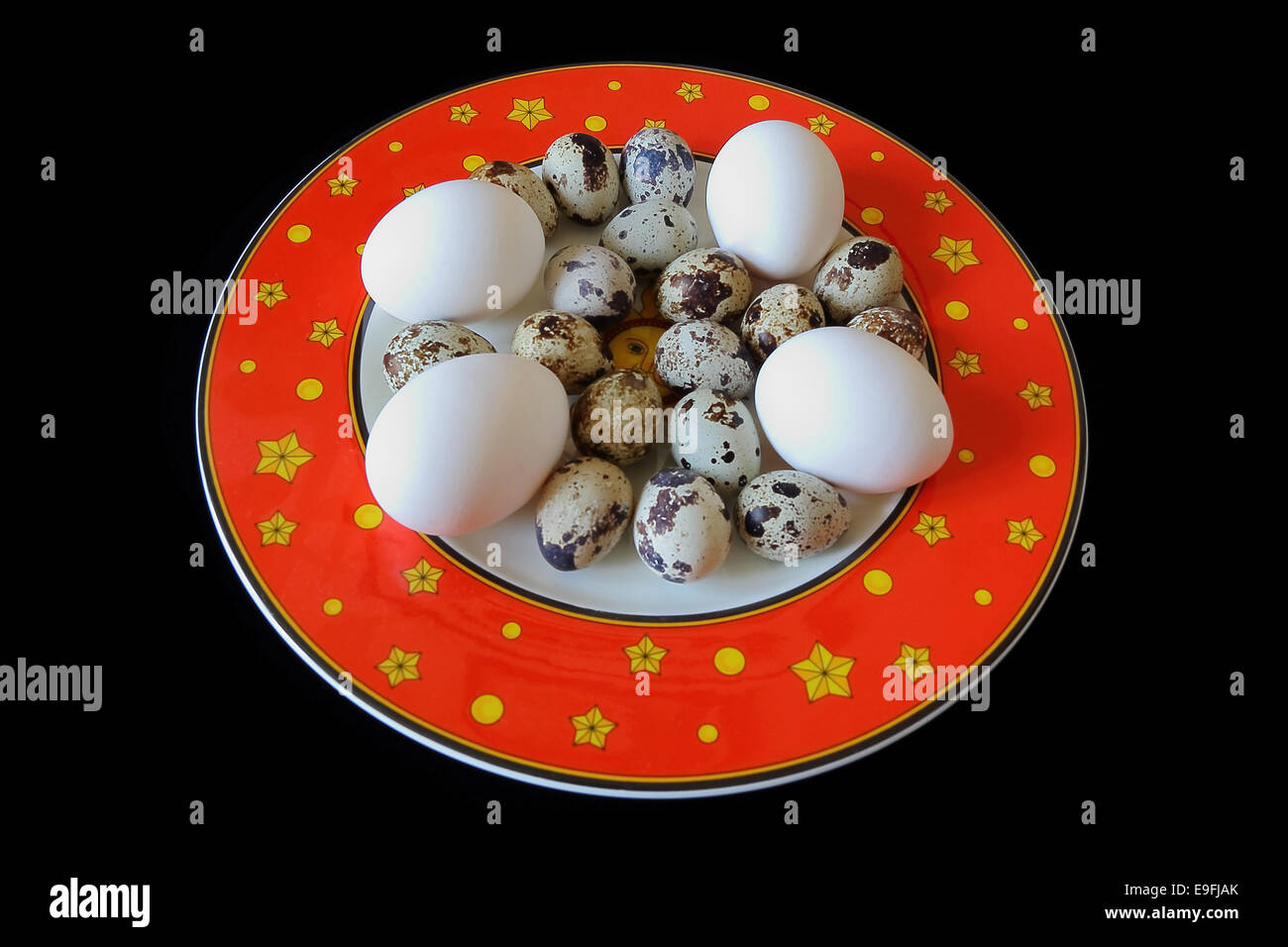 Red dish with hen and quail eggs Stock Photo - Alamy