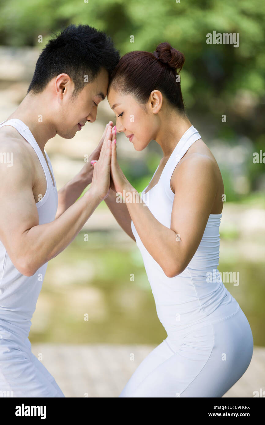 Young couple doing yoga Stock Photo - Alamy