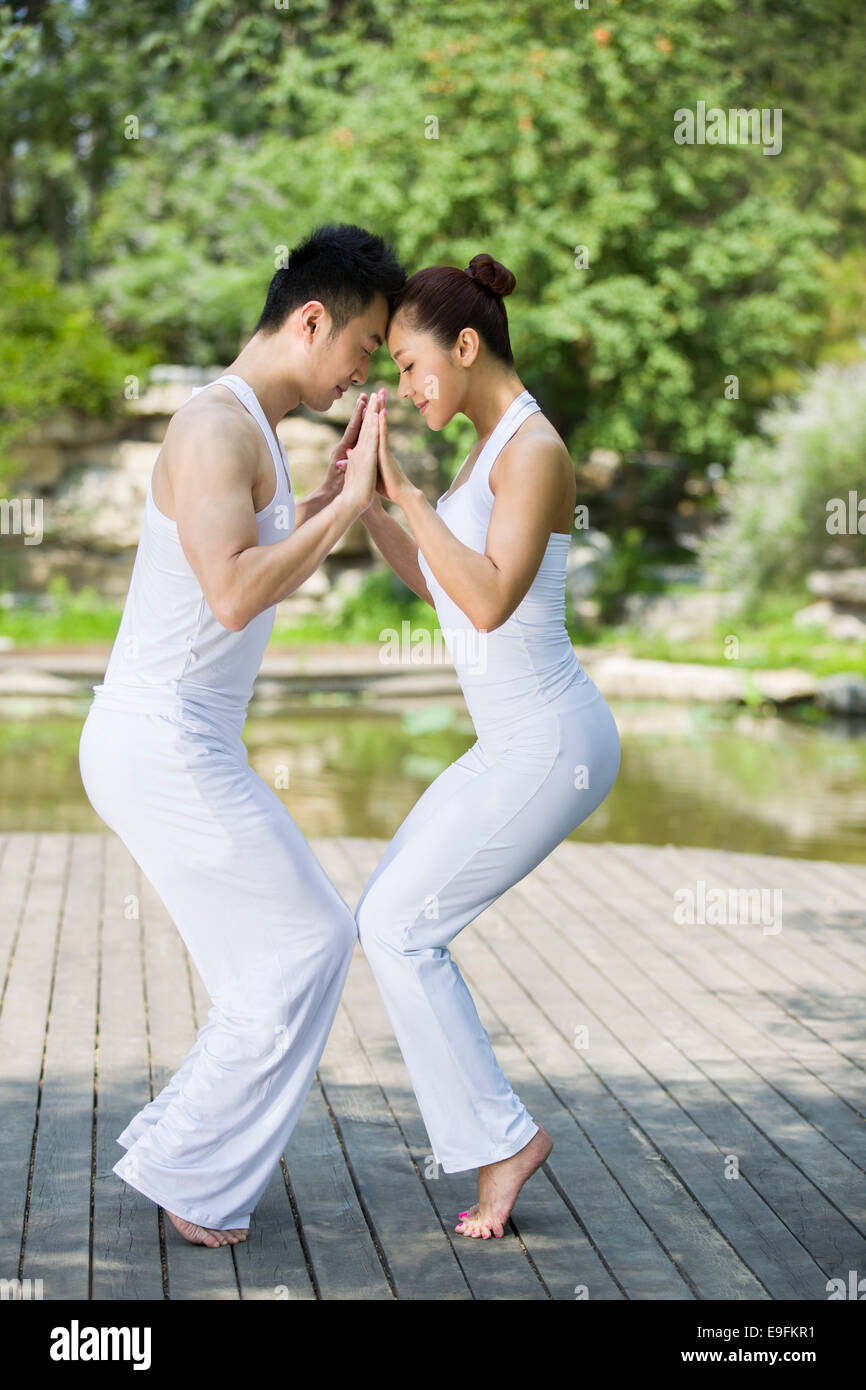 Young couple doing yoga Stock Photo - Alamy