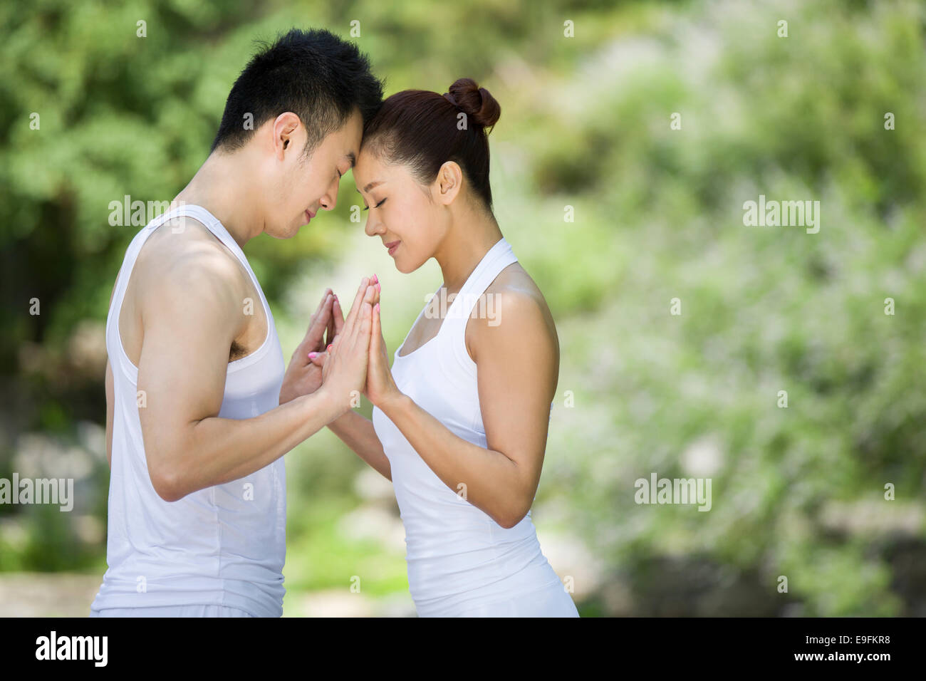 Young couple doing yoga Stock Photo - Alamy