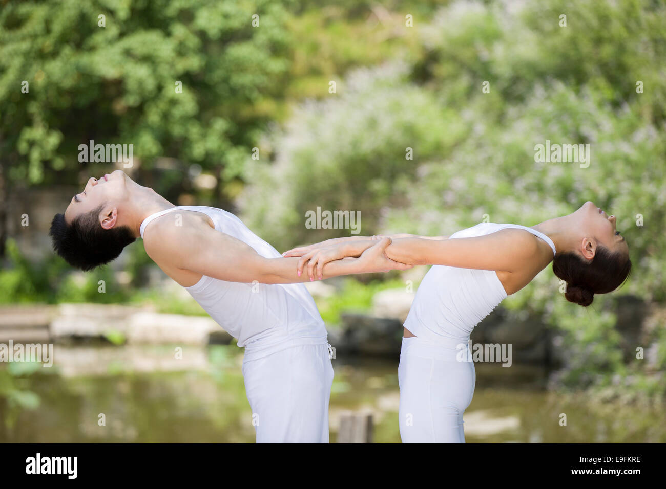 Young couple doing yoga Stock Photo - Alamy