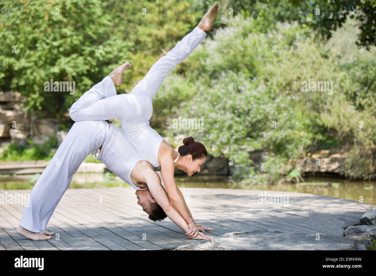 Young couple doing yoga Stock Photo - Alamy
