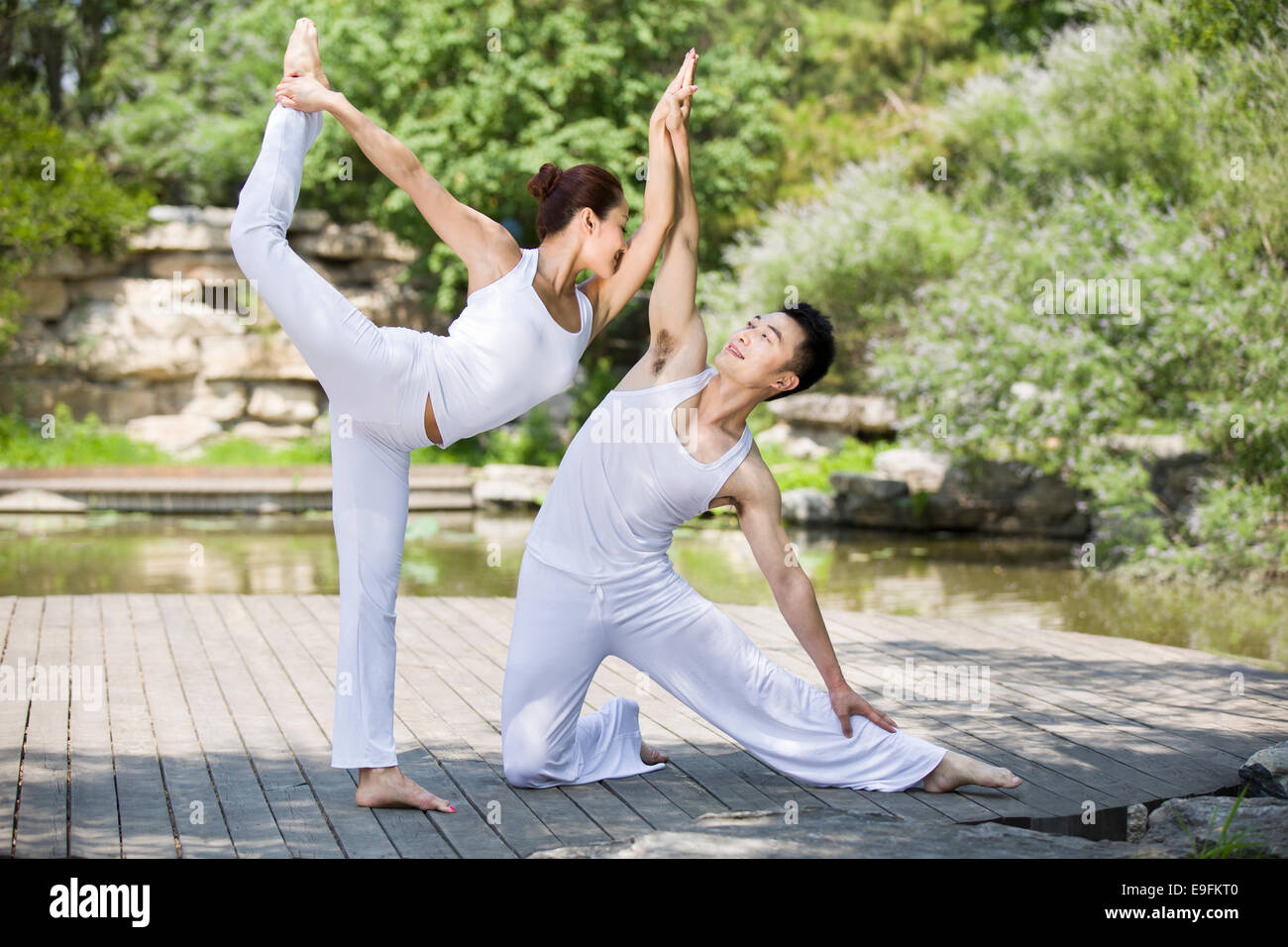 Young couple doing yoga Stock Photo - Alamy
