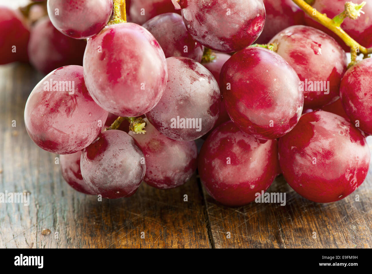 Red grapes on table Stock Photo - Alamy