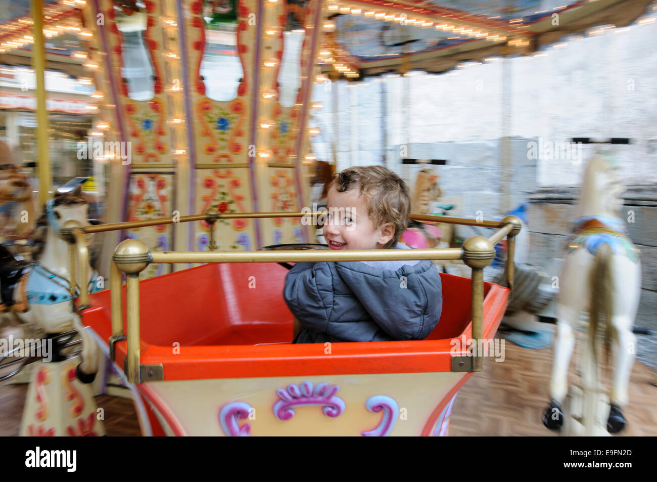Children merry go round playground hi-res stock photography and images ...