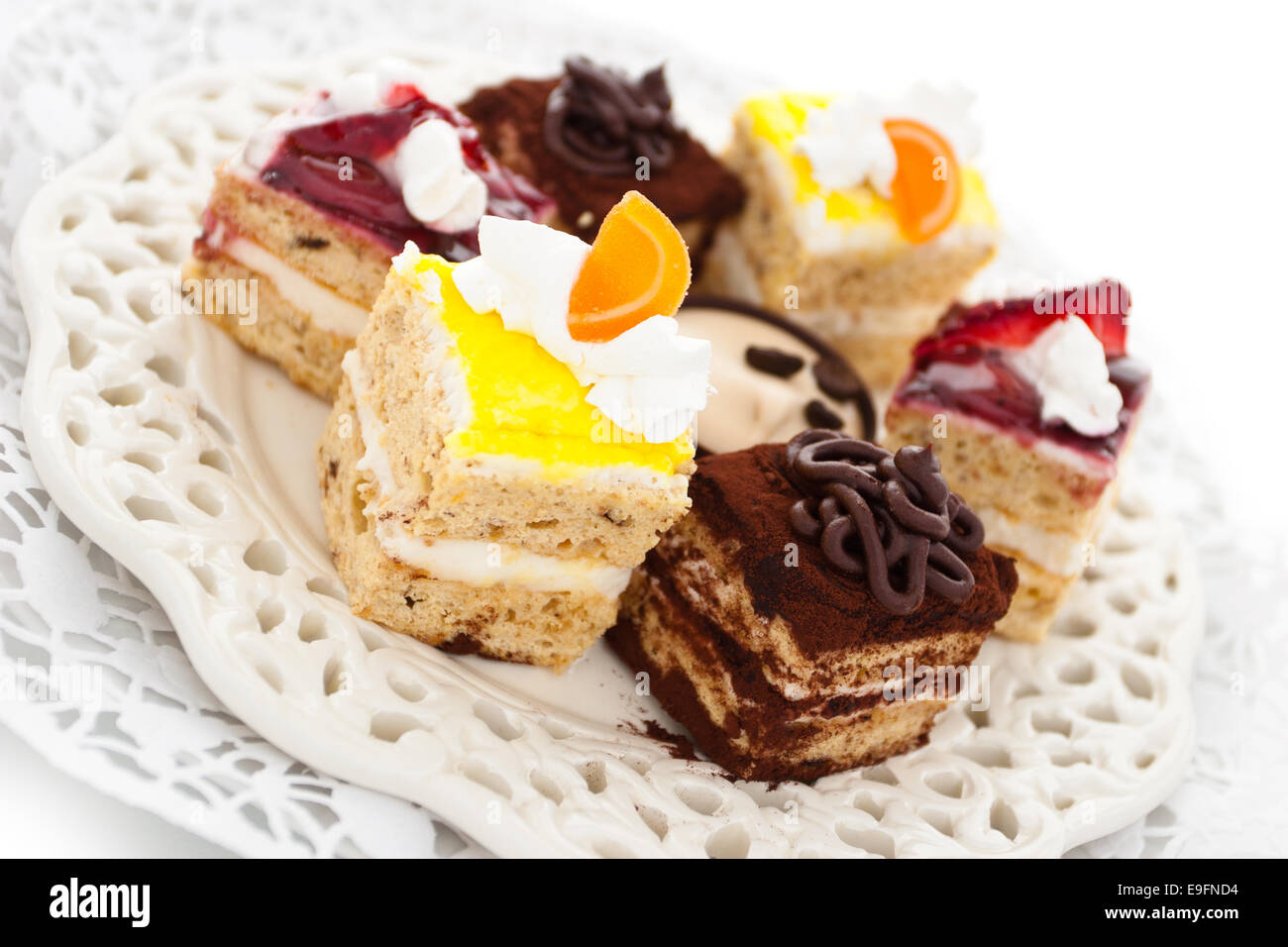 Collection of different small cakes on plate Stock Photo - Alamy