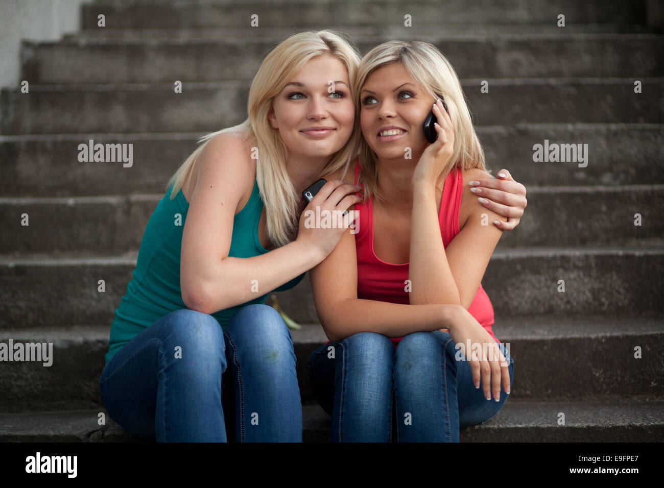 Two women sitting on stairs hi-res stock photography and images - Alamy