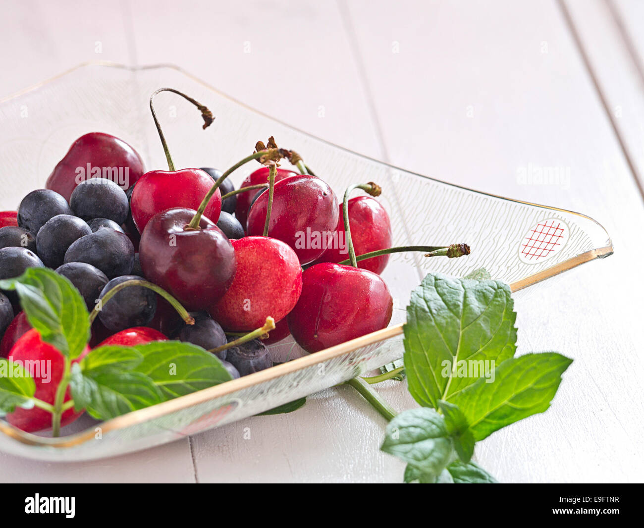 Blueberries and cherries in a glasbowl Stock Photo - Alamy
