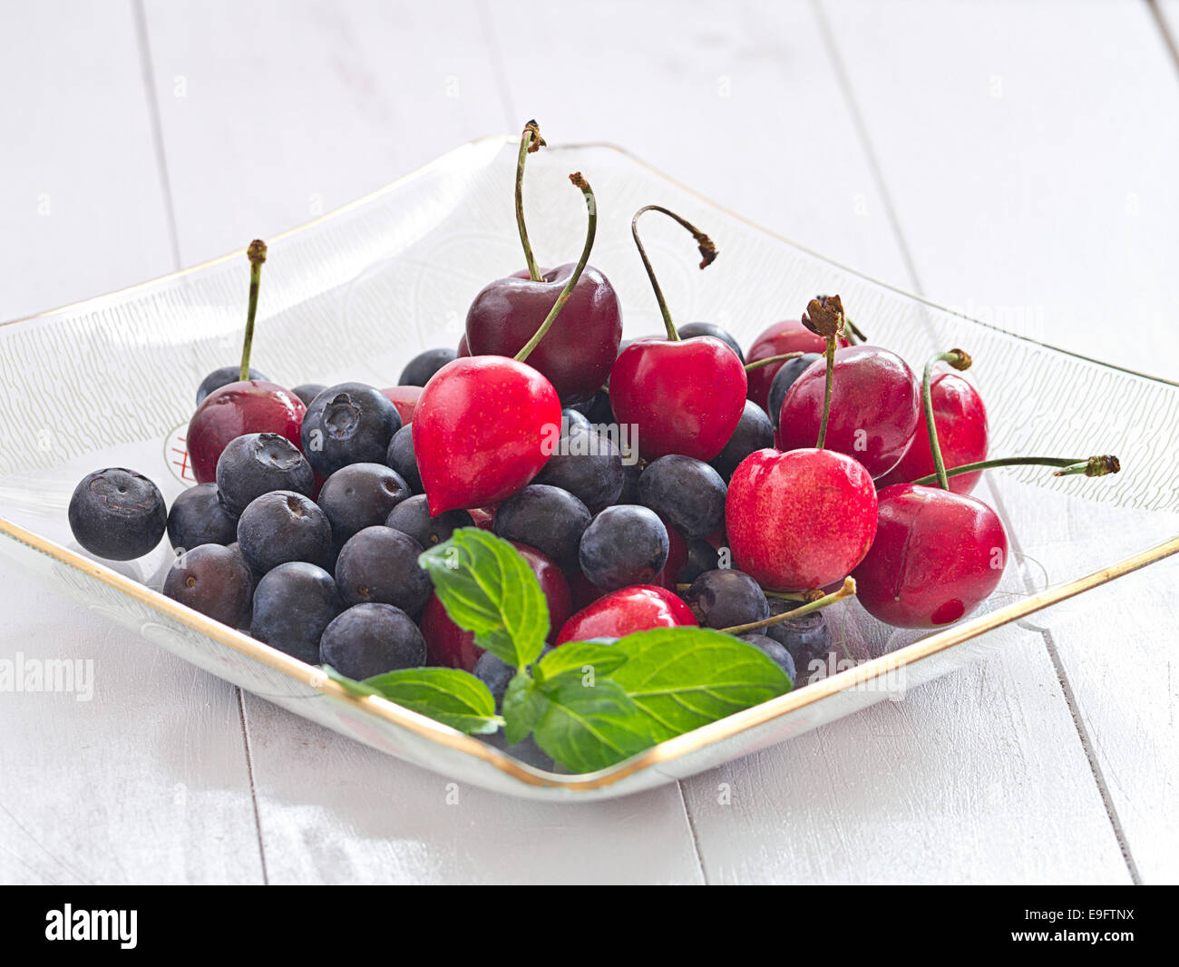 Blueberries and cherries in a glasbowl Stock Photo - Alamy