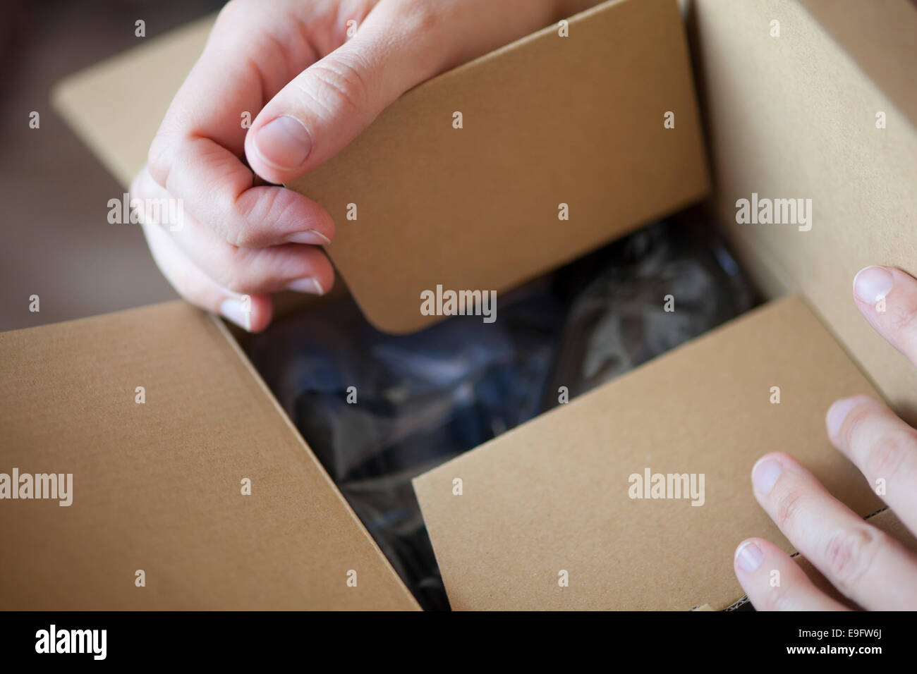 Woman's hands opening cardboard box Stock Photo - Alamy