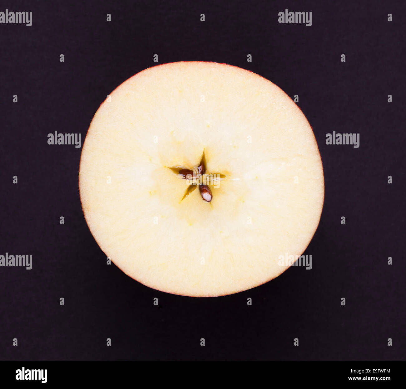 One half of apple on black background. Top view Stock Photo - Alamy