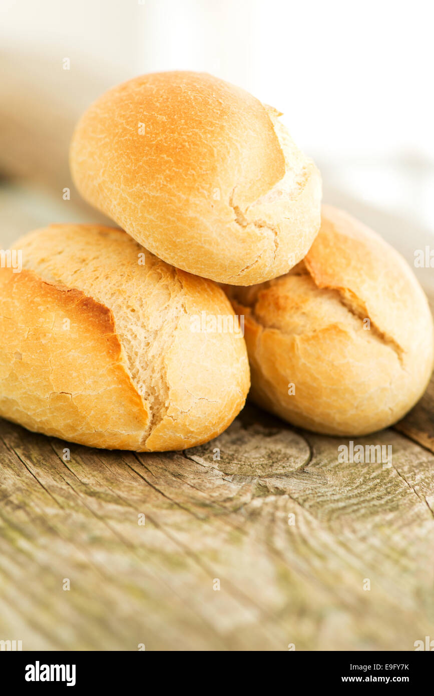 Pile of Bread on wooden table close up Stock Photo - Alamy